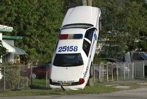 Florida cop 'parks' his car up a light pole